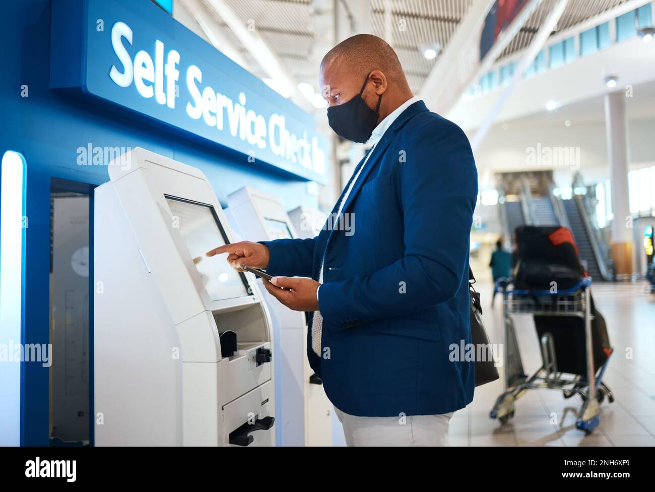 Covid, travel and self service with black man and phone in airport for ...