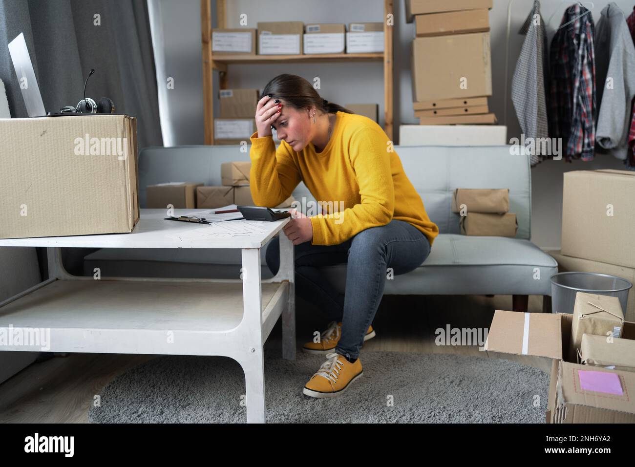 Female small business owner thoughtful serious doubtful in stress worry ...