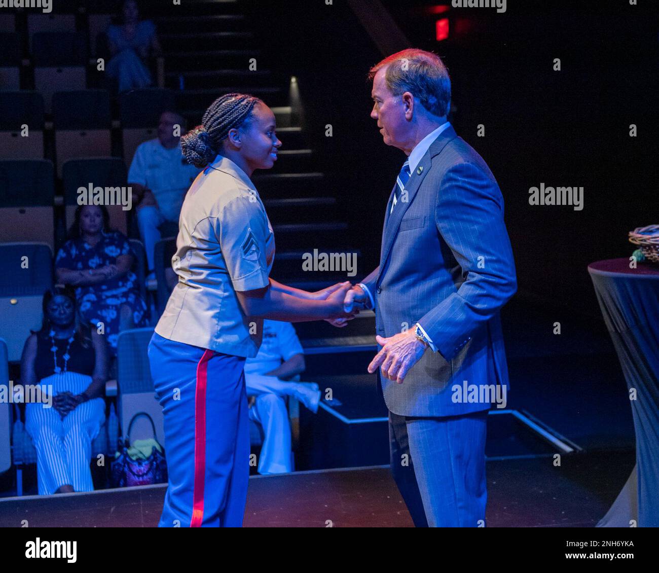 The Hampton Roads Chamber President Bryan Stephens presents a coin to ...