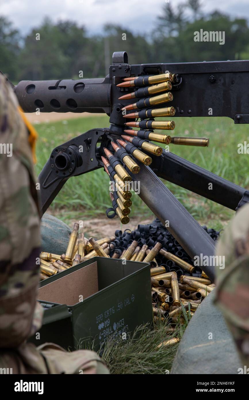 A belt of .50-caliber rounds feed into an M2 machine gun during a ...