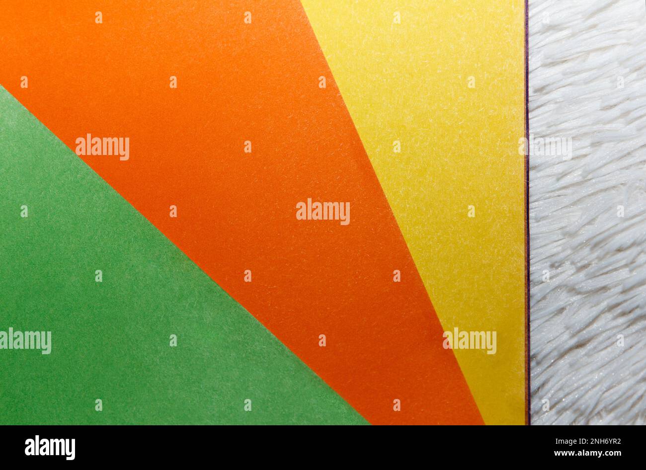 A bundle of high-quality colored paper lies on a white background ...