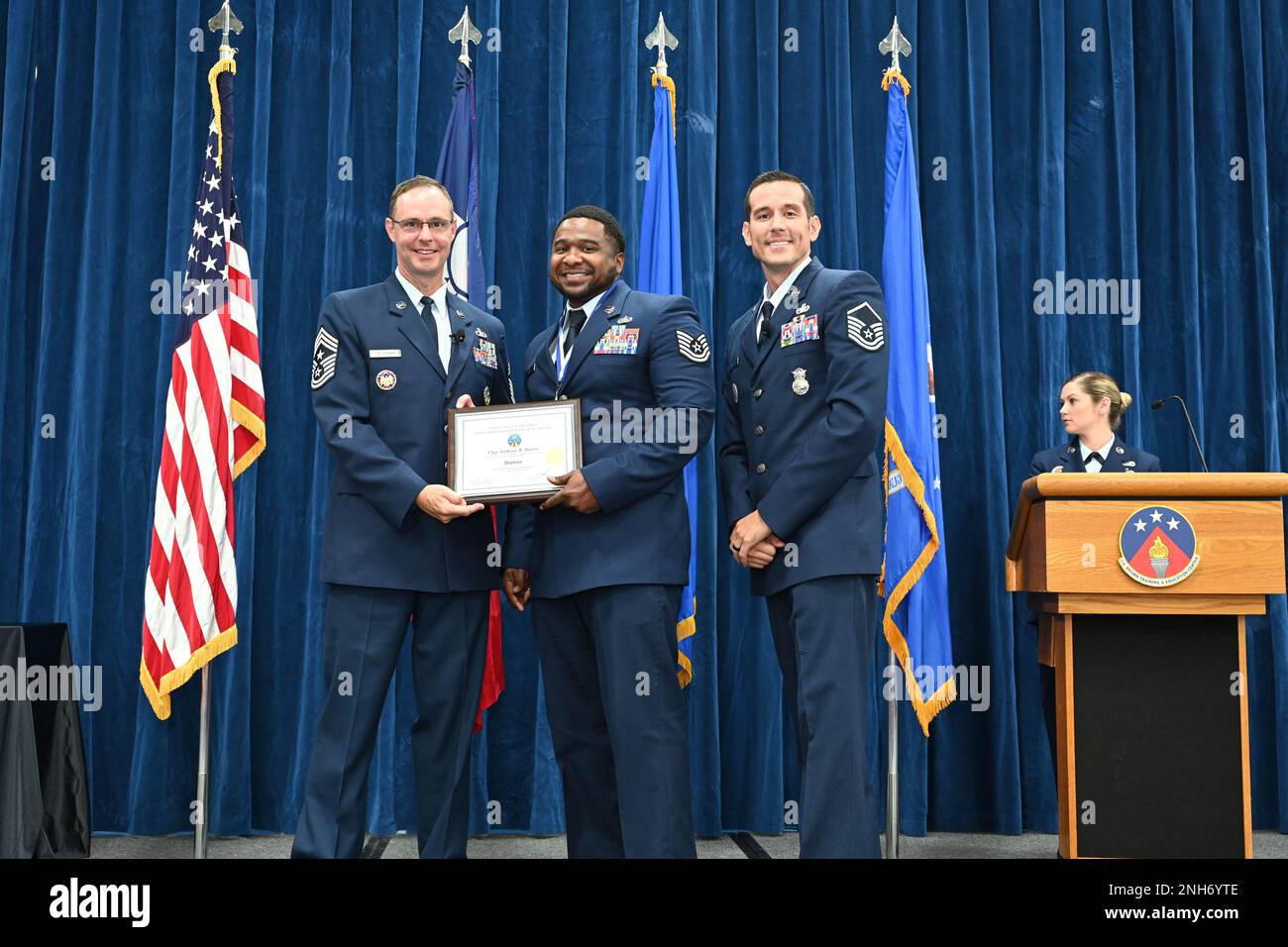U.S. Air Force Tech. Sgt. Anthony Harris receives the Distinguished Graduate Award during the ...