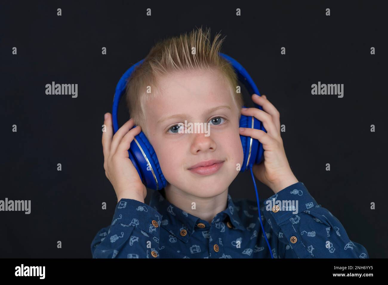 Little boy listening music with Headphones Stock Photo - Alamy