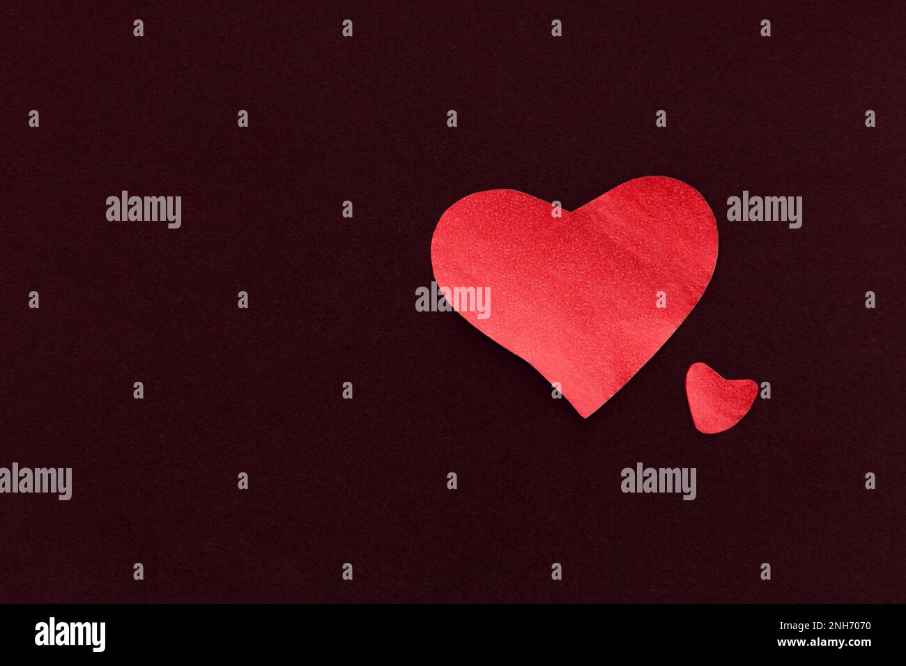 Red sparkling heart on a black background, made of paper, romantic and ...