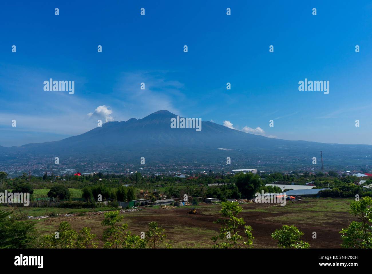 Indonesian country side with mountain and blue sky Stock Photo - Alamy
