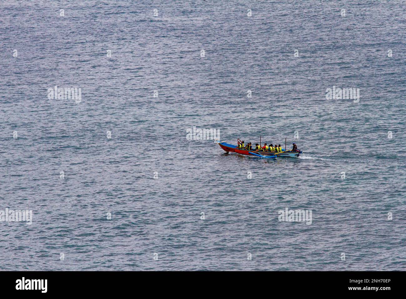 Aerial view of small tourist boat through the bay area in Indonesia on ...