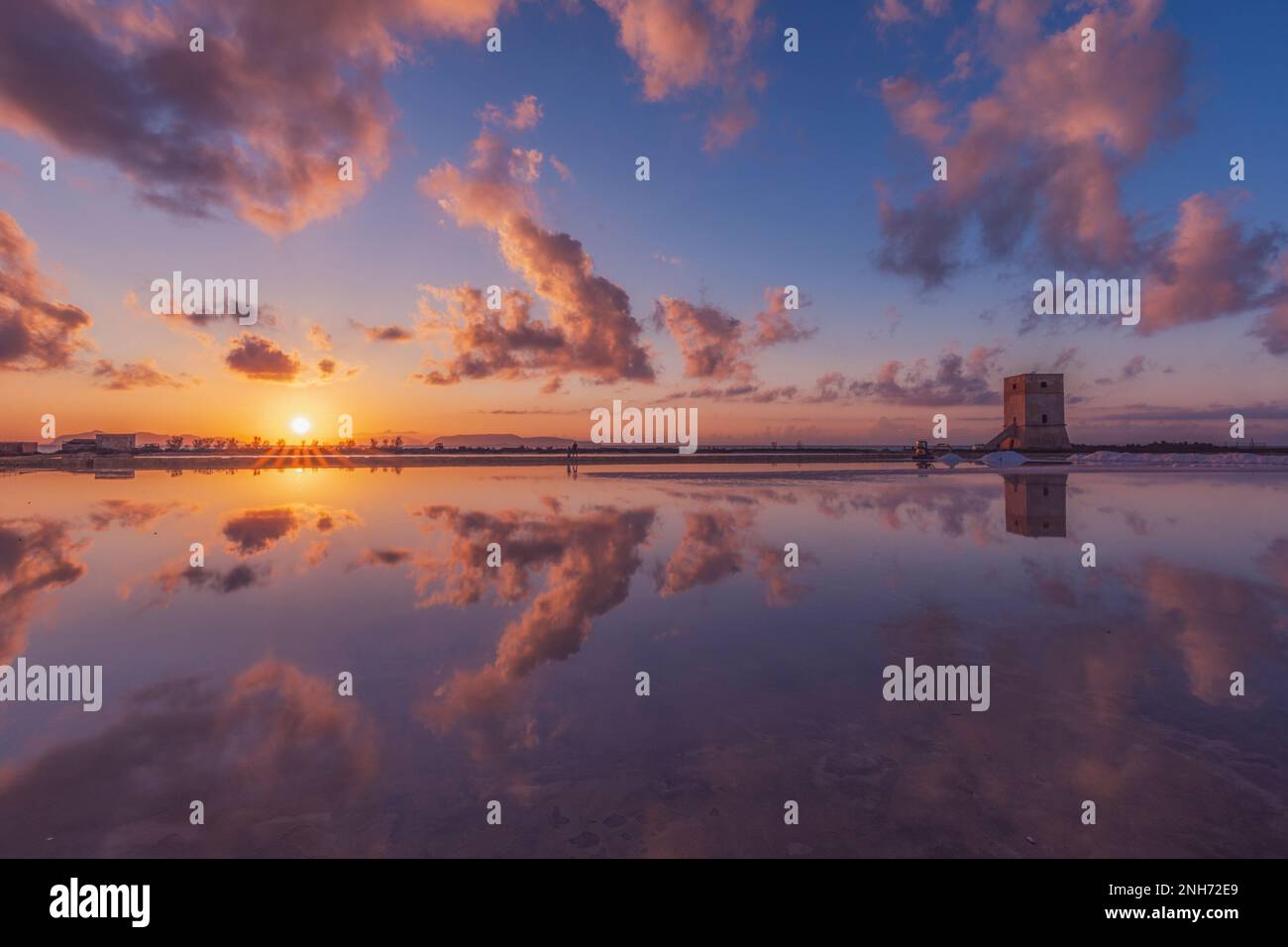 Clouds at sunset reflected on the water, salt pans of Trapani Stock ...