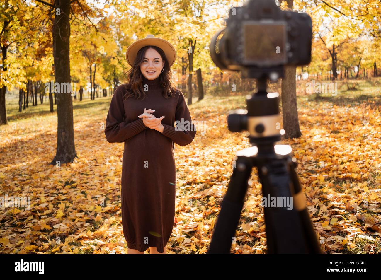 Young woman taking video for vlog on dslr camera. Female blogger ...