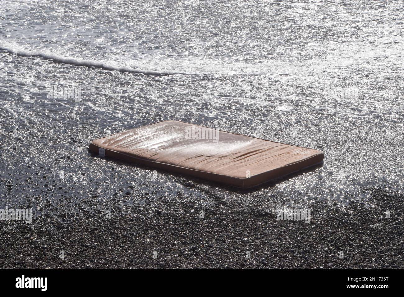 A discarded old mattress on a beach makes its way into the sea Stock ... A discarded old mattress on a beach makes its way into the sea Stock ...