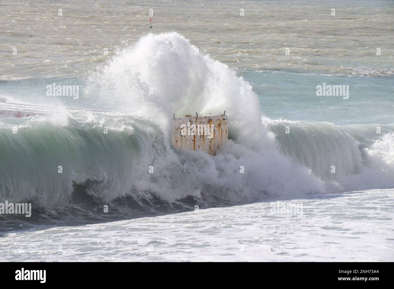 Waves smash against an old jetty in Nice, South of France Stock Photo ...
