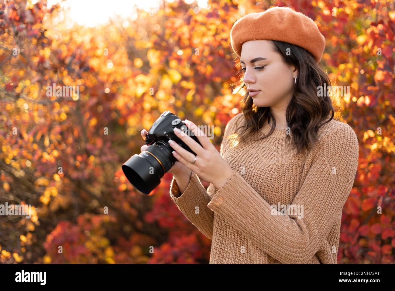 Young woman photographer holding camera taking pictures photos of ...