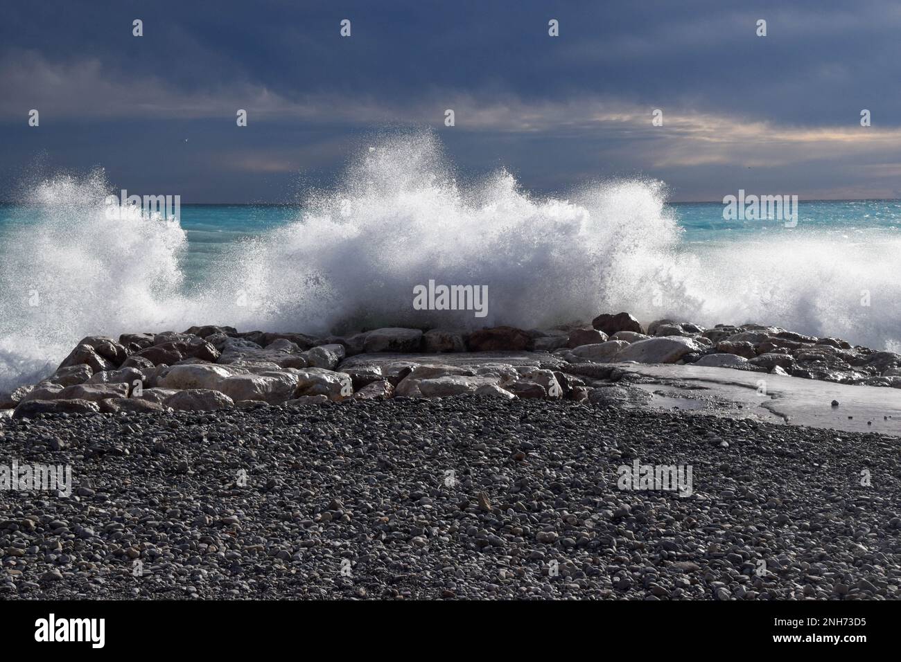 Sea waves splash against rocks on a beach Stock Photo - Alamy