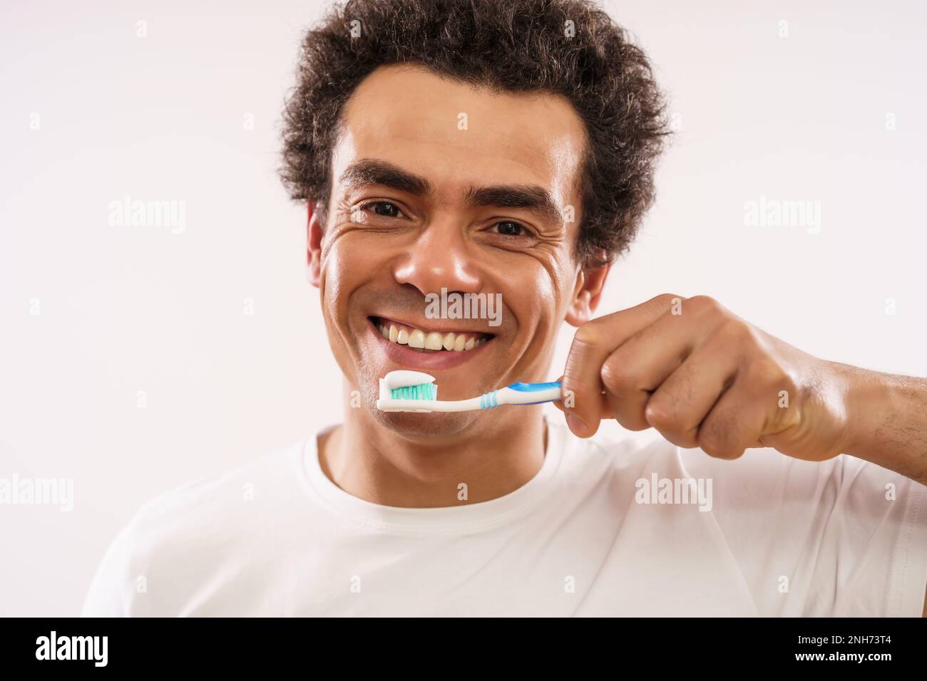 Handsome mixed race adult man is ready for cleaning his teeth Stock ...
