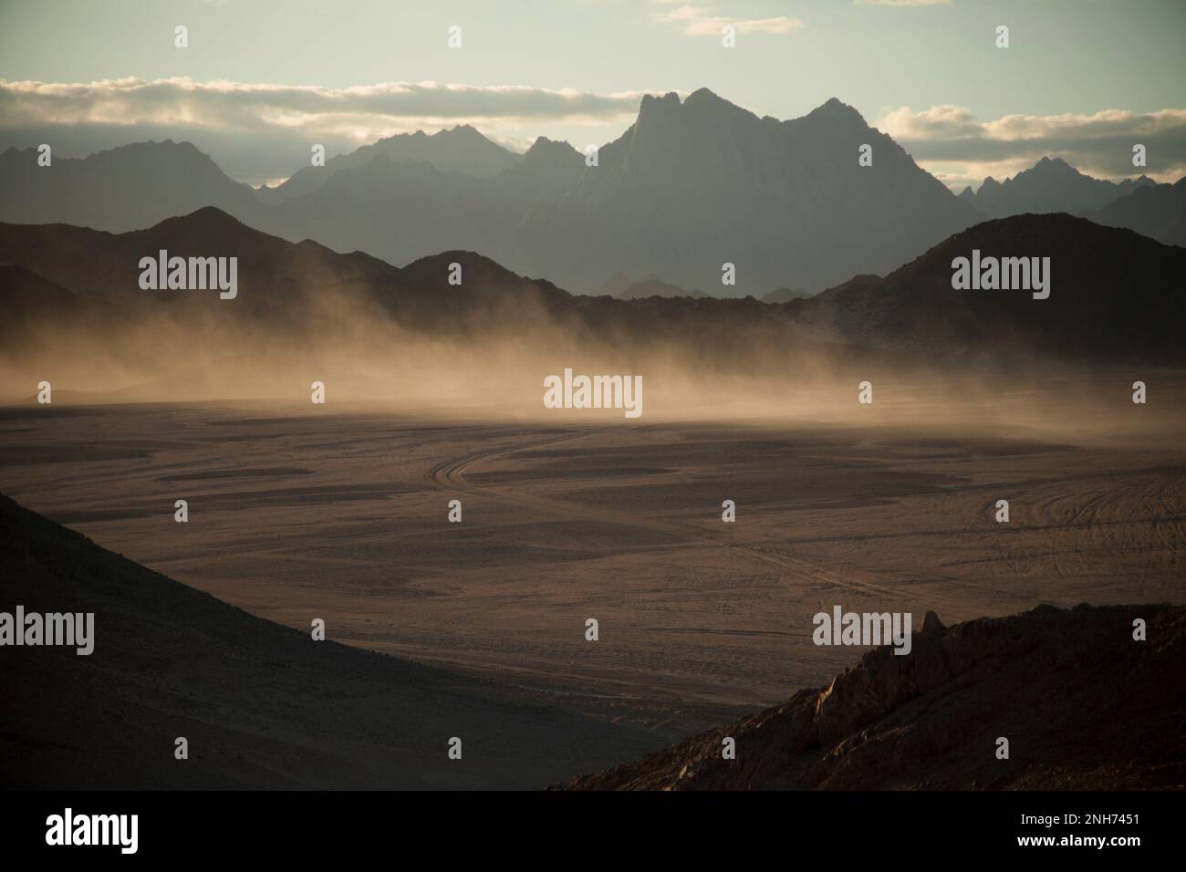 Beach buggy dust trail in air by mountains in Eastern Desert, Egypt ...