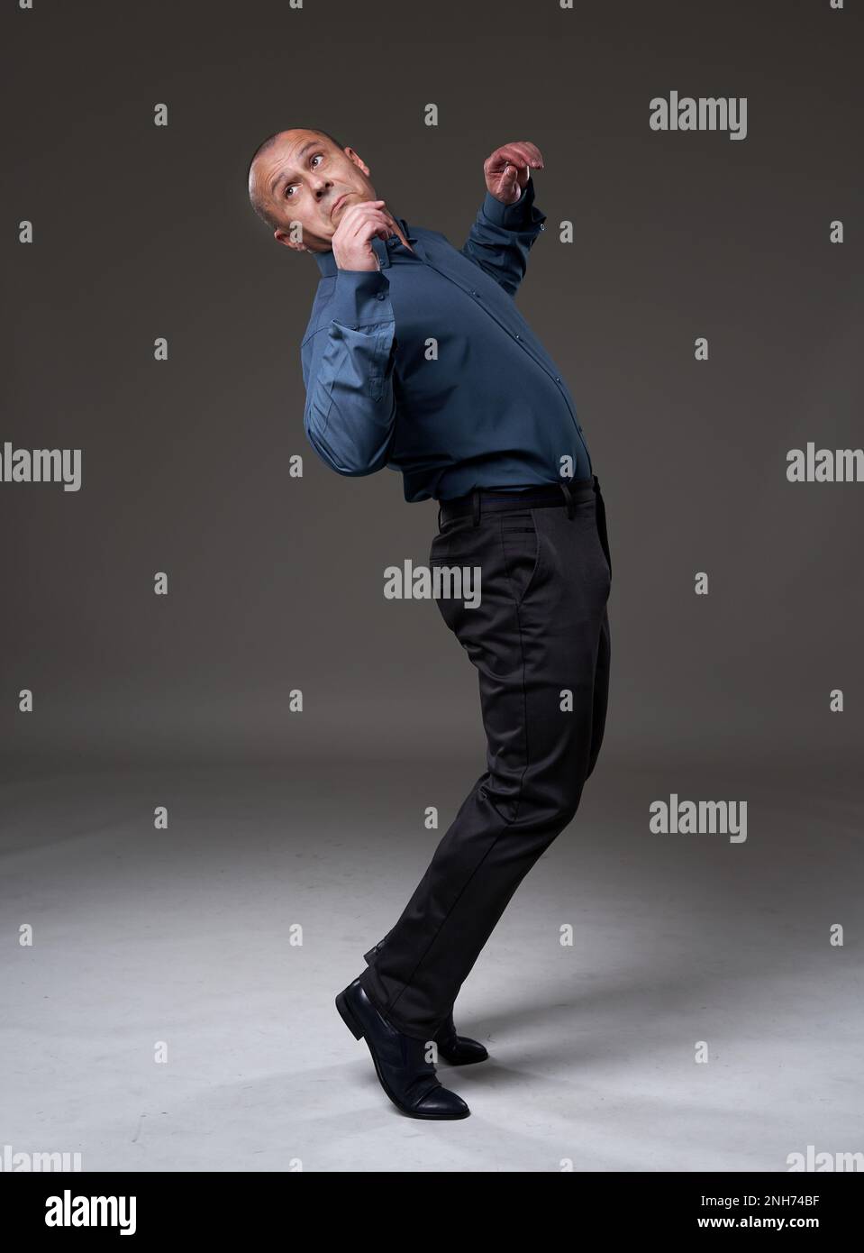 Full length of a businessman falling over, as pushed by an invisible ...