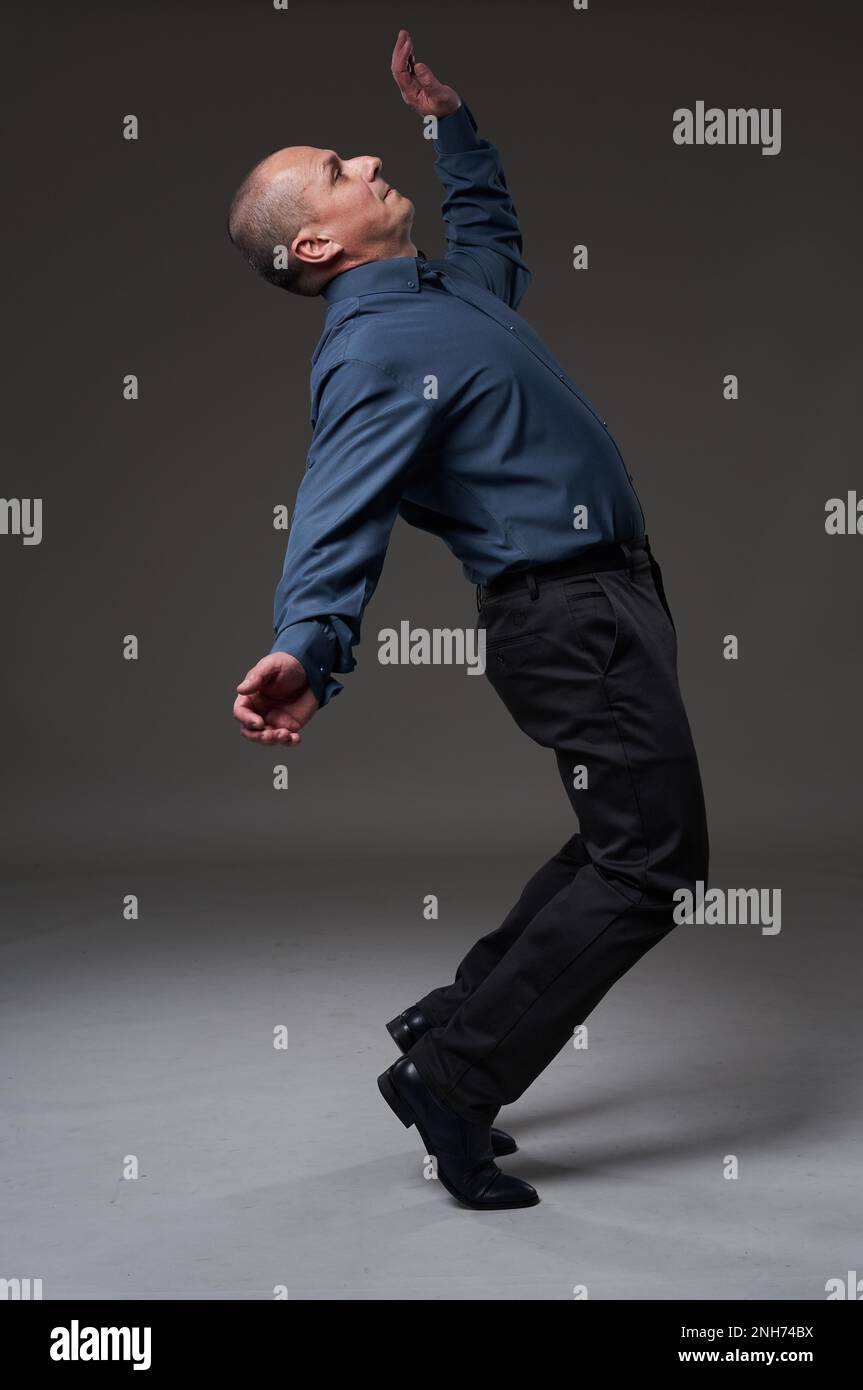 Full length of a businessman falling over, as pushed by an invisible ...