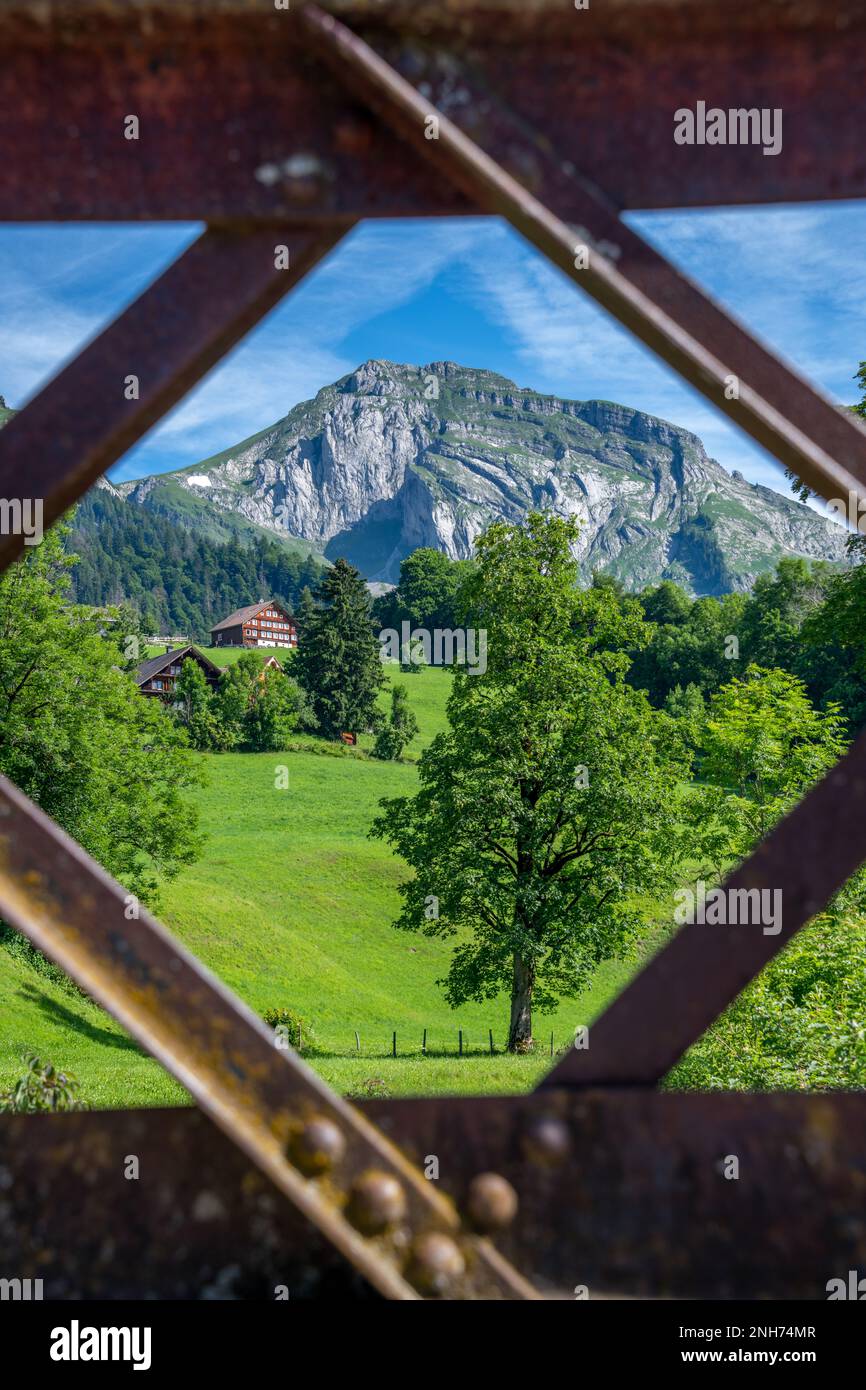 A swiss mountain landscape seen through a steel frame of a bridge Stock ...