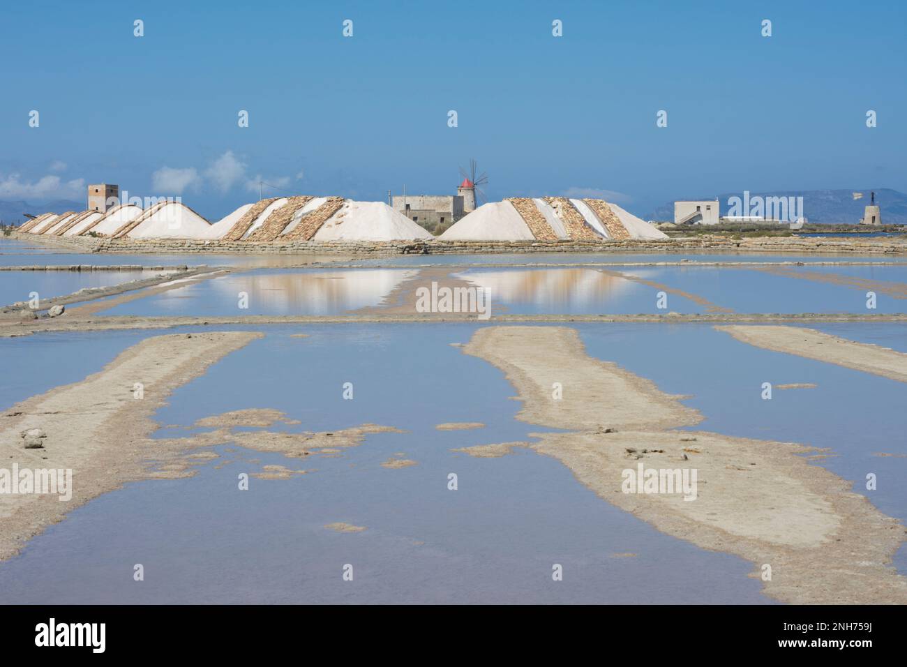 Heaps of raw salt covered with terracotta tiles, salt pans of Trapani ...