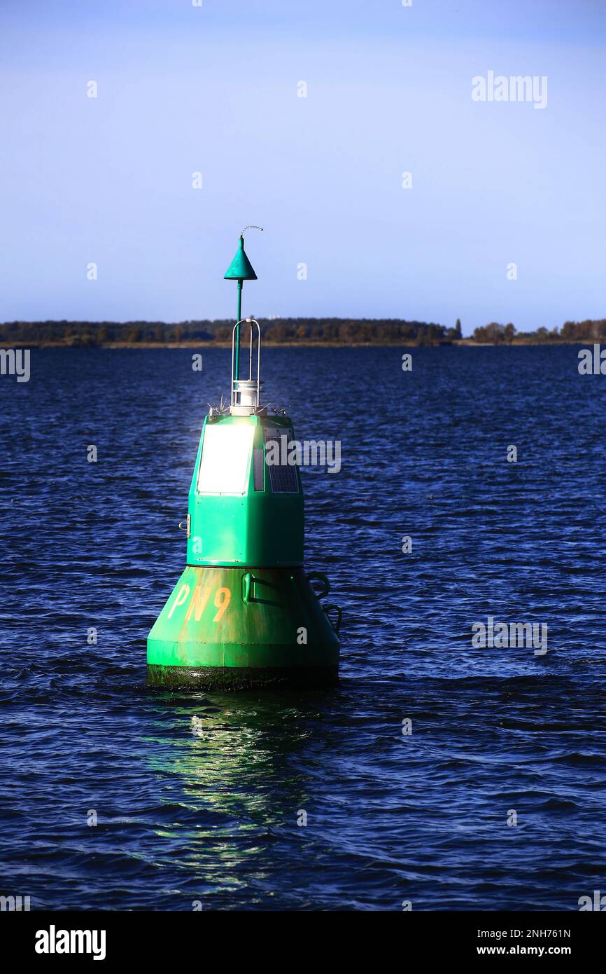 Green buoy in the Baltic Sea reflecting bright sunlight Stock Photo - Alamy
