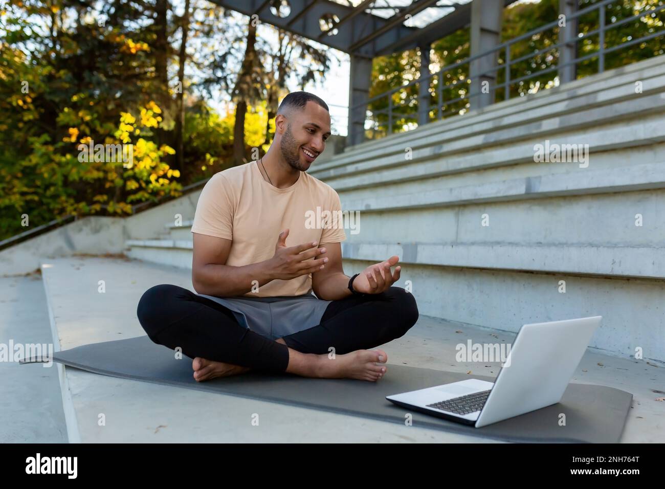 Young African American athlete fitness trainer conducts online training ...