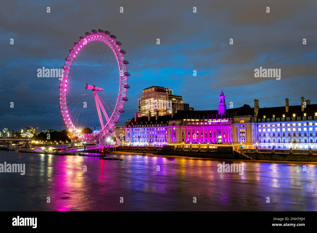 London Eye and river Thames illuminated at night in London, UK Stock ...