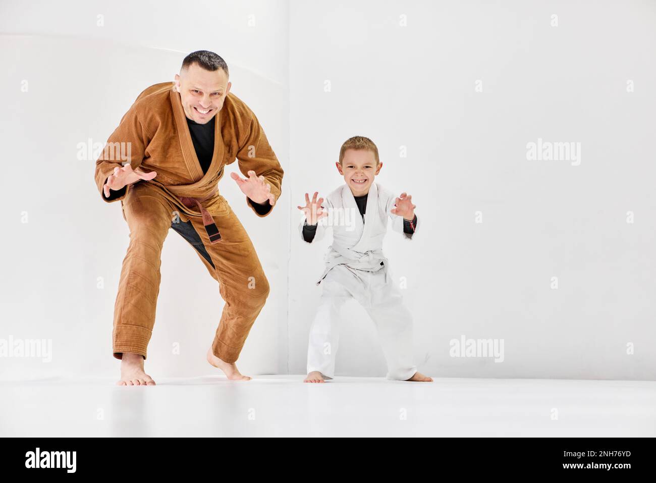 Coach, professional judo, jiu-jitsu trainer in uniform posing with ...