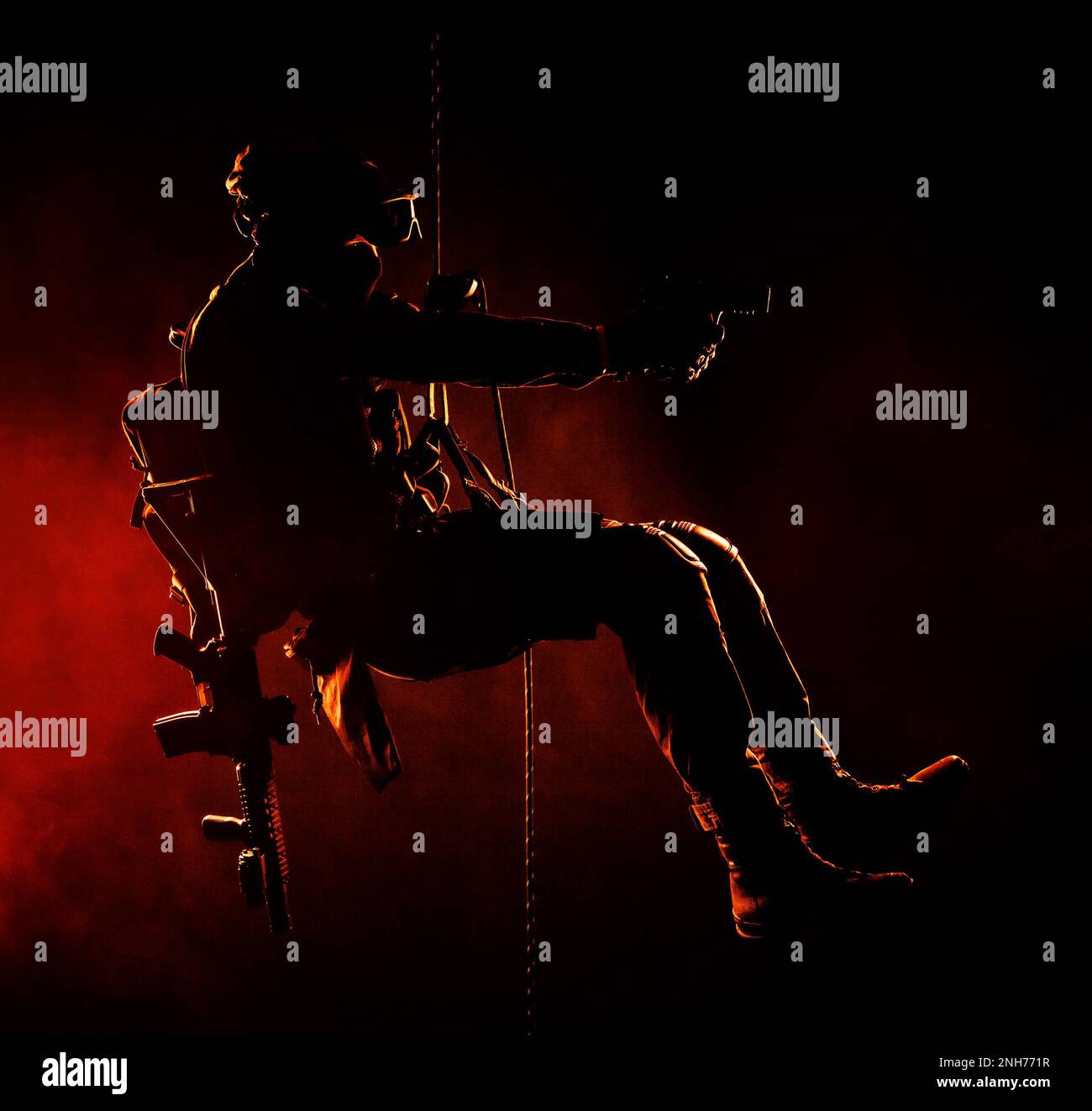 Silhouette of police officer in tactical gear descending from a height ...