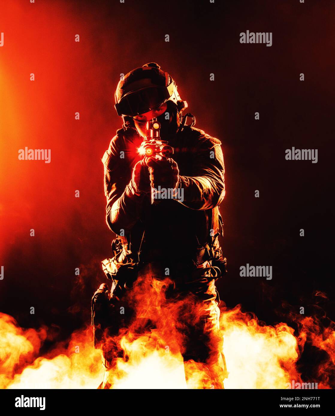 A silhouette of a soldier in fire and smoke, danger and intensity of ...