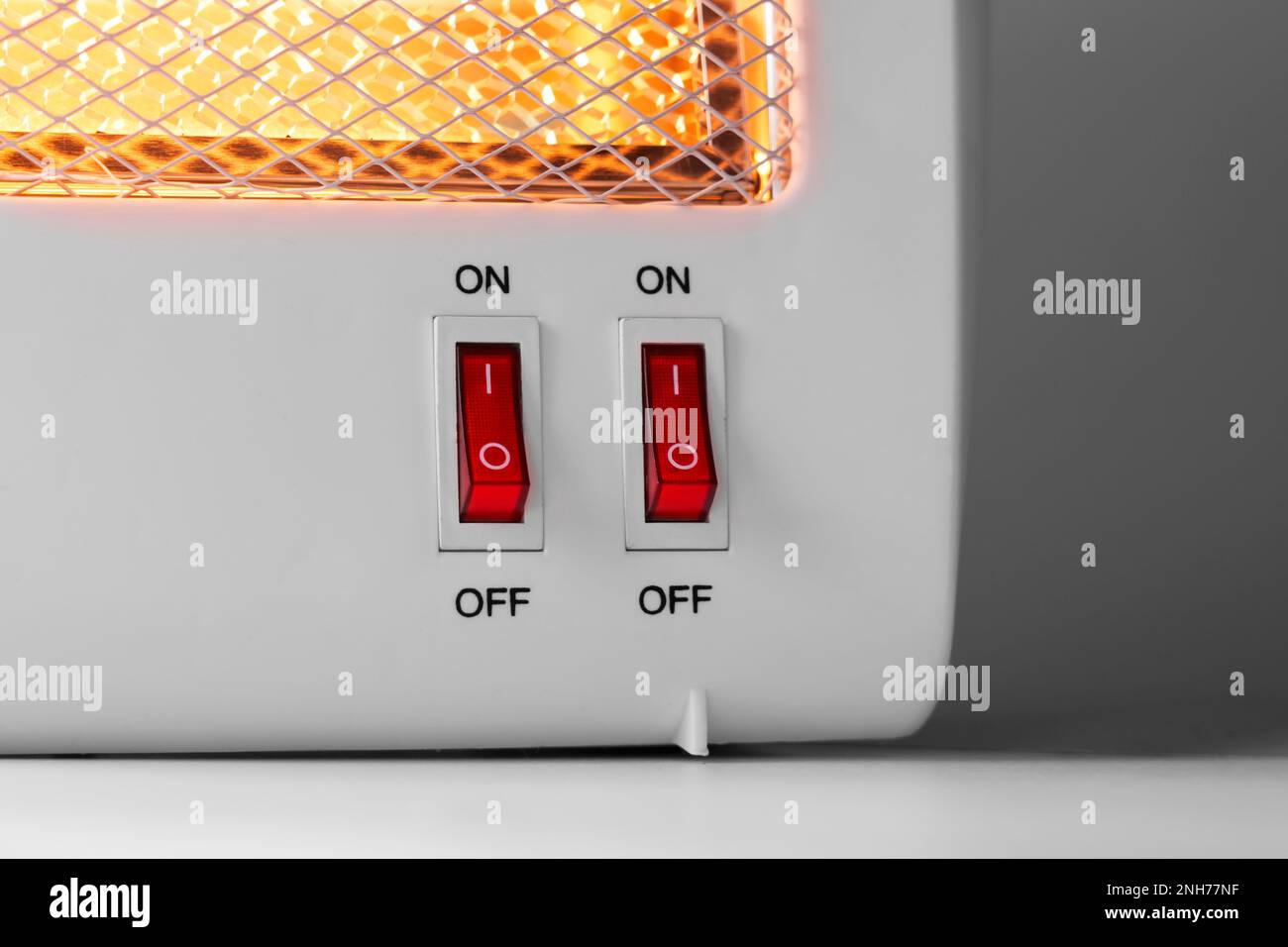 Electric halogen heating lamp with red switches for power adjustment ...