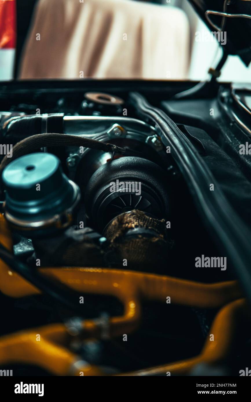 An engine of a classic car with the hood up, giving a clear view of the ...