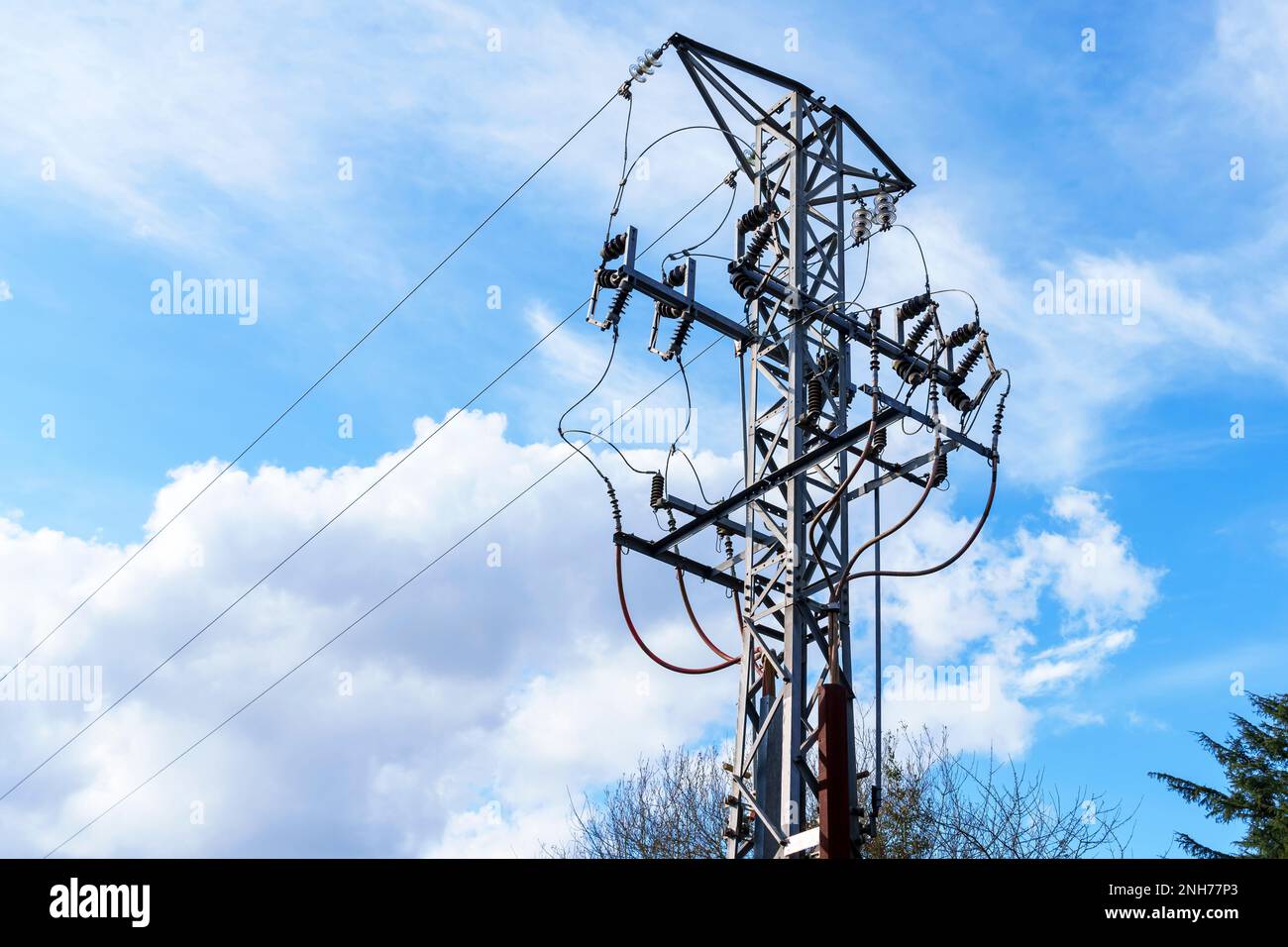 High voltage electric line with metal pylon on sky background ...