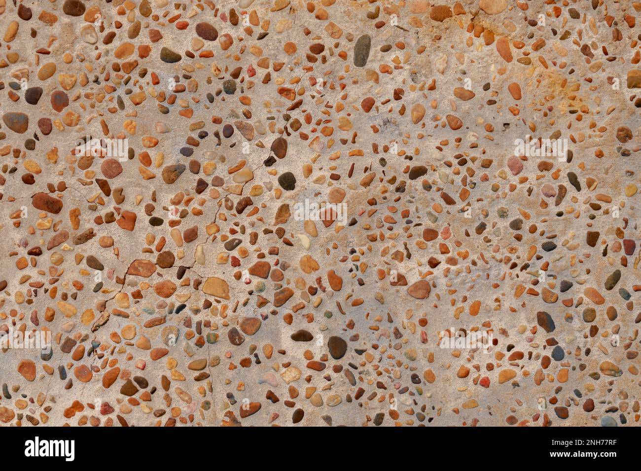 Colored pebble stone wall of the building exterior. Abstract ...