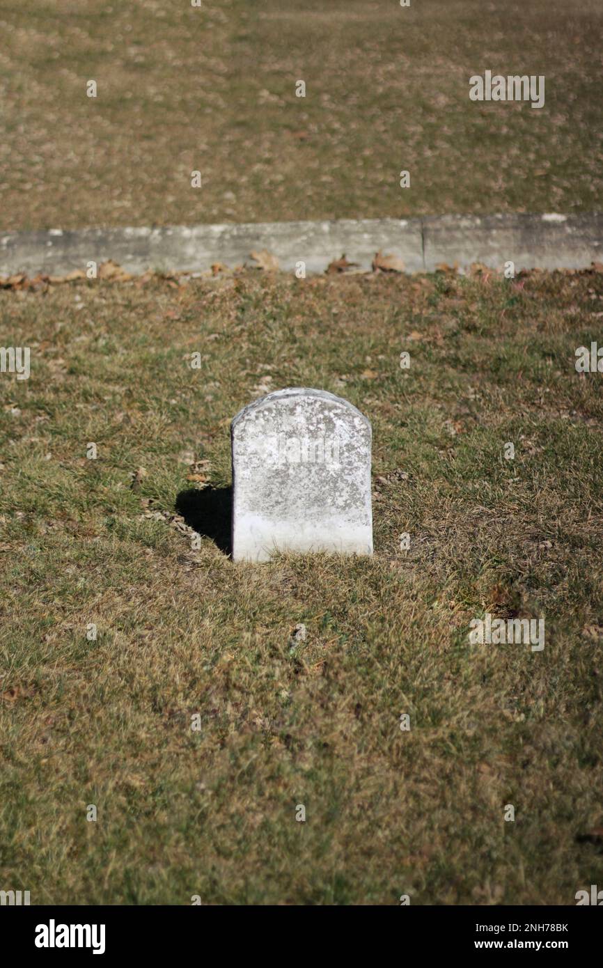 Typical common worn and weathered limestone tombstone with a blank ...