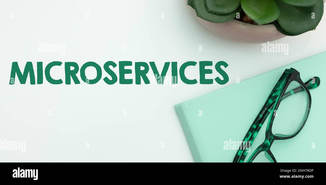 Hand writing sign Microservices. Word Written on Software development technique Building single ...