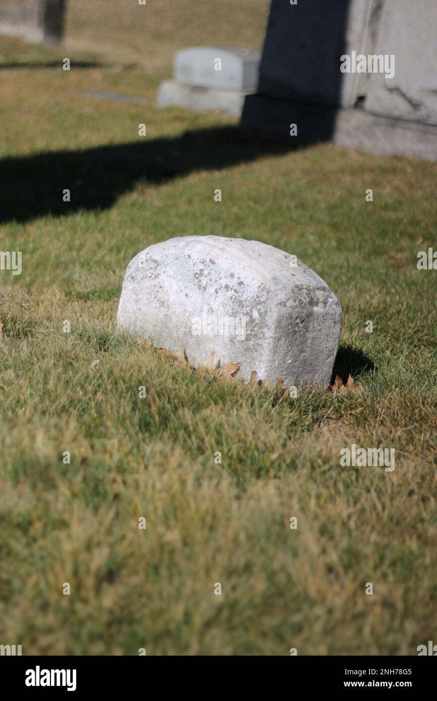 Typical common worn and weathered limestone tombstone with a blank ...