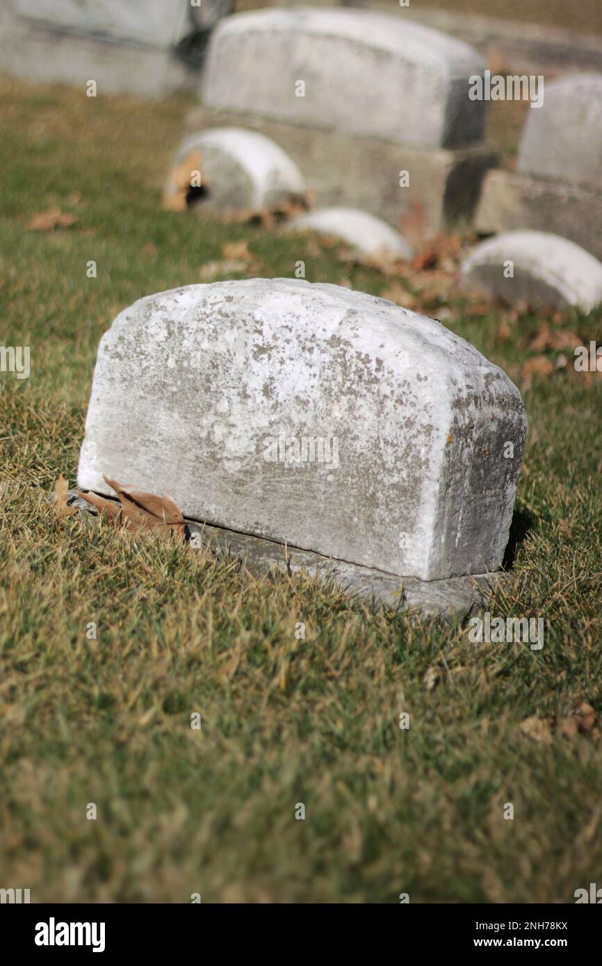 Typical common worn and weathered limestone tombstone with a blank ...