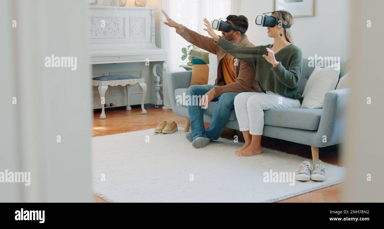 VR gamer couple, metaverse or futuristic tech on sofa in living room ...