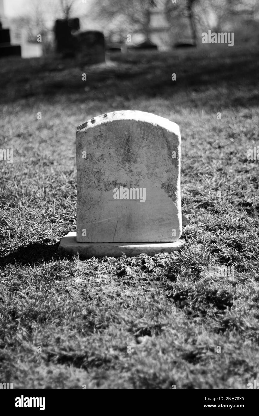 Typical common worn and weathered limestone tombstone with a blank ...