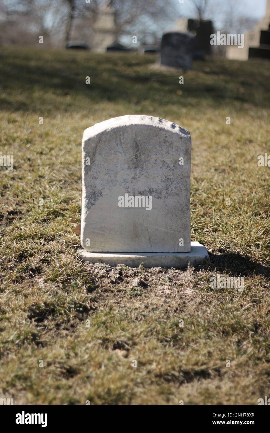 Typical common worn and weathered limestone tombstone with a blank ...