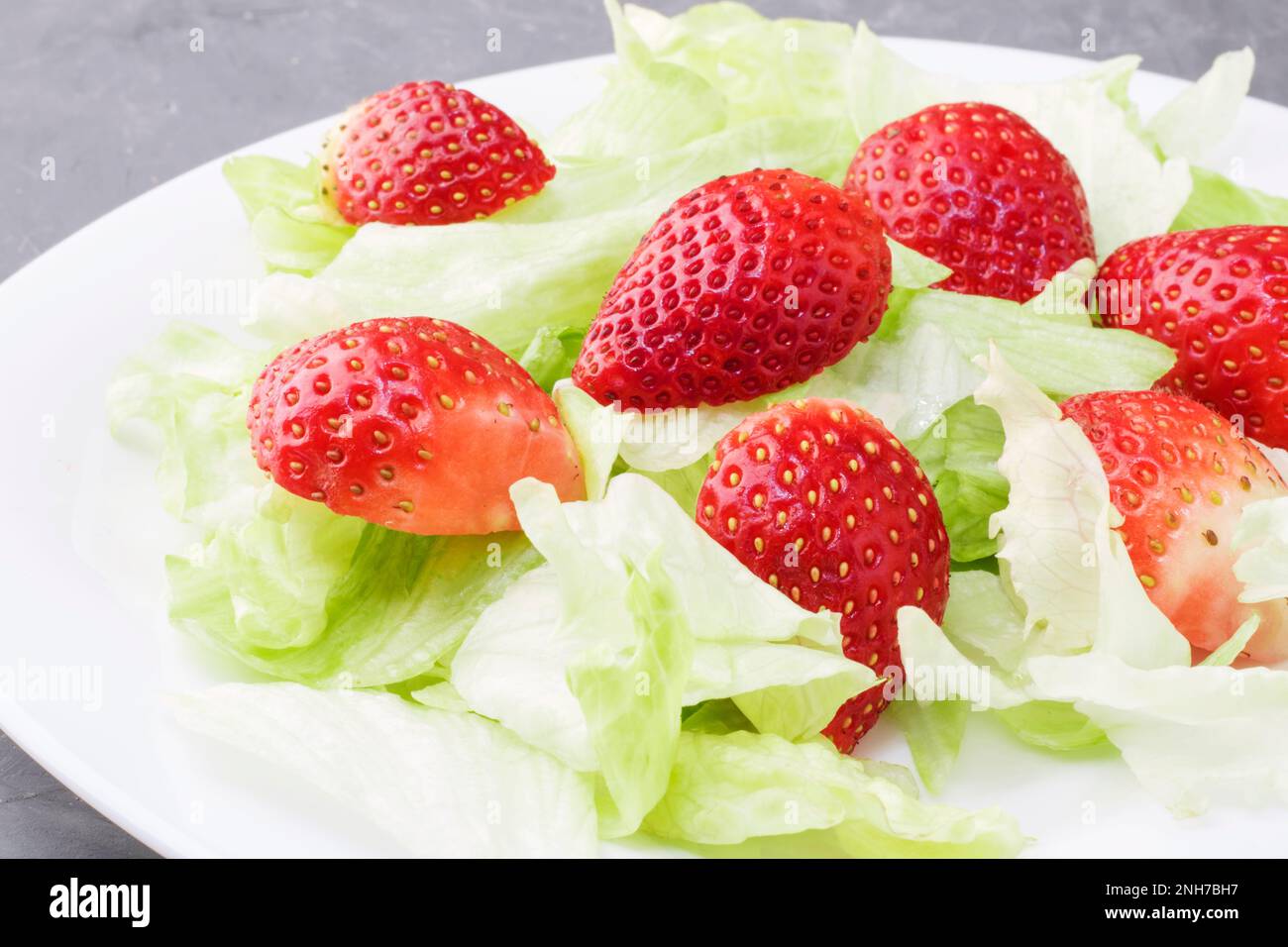 Healthy summer diet salad with strawberries and leaves iceberg lettuce ...