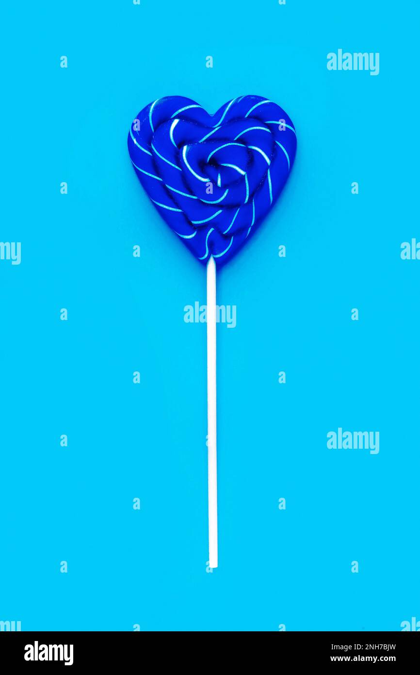 Classic Blue color of the Year 2020. Blue lollipop heart shaped on blue ...