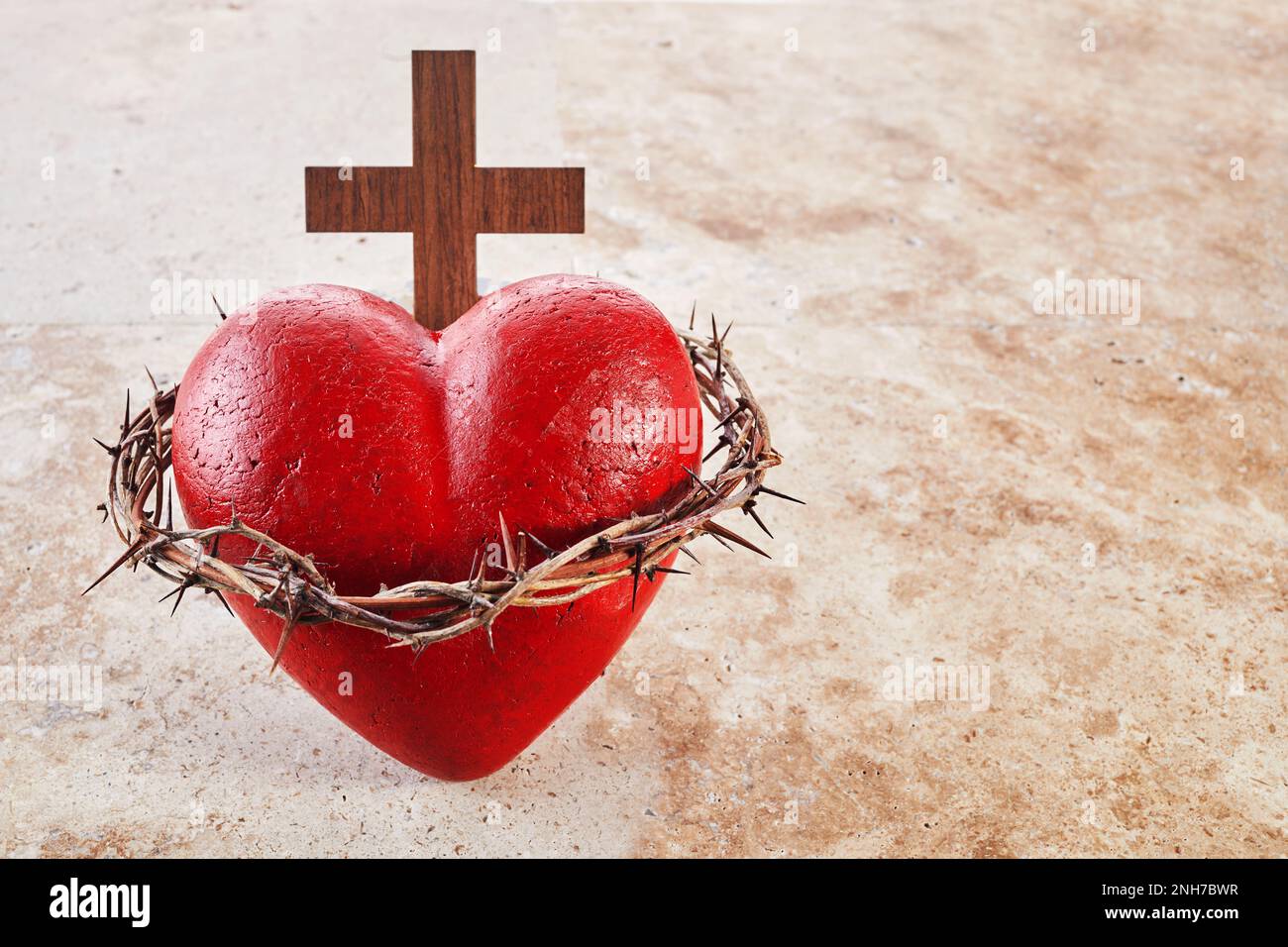 Sacred Heart of Jesus, surrounded by a crown of thorns and with wooden cross Stock Photo - Alamy