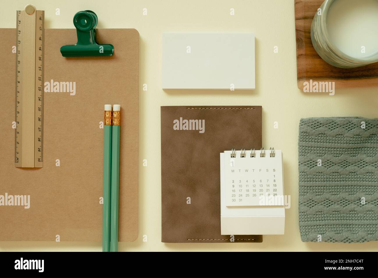 Office supply, stationery. Brown notebook, calendar, cup of milk ...