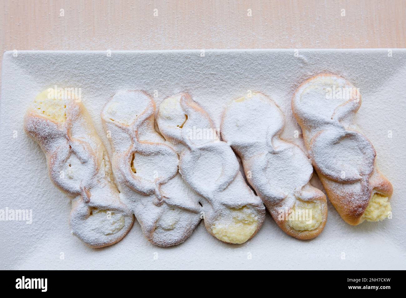 on rectangular white porcelain plate slowly sprinkle cottage cheese ...