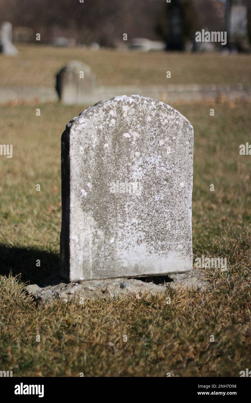 Typical common worn and weathered limestone tombstone with a blank ...