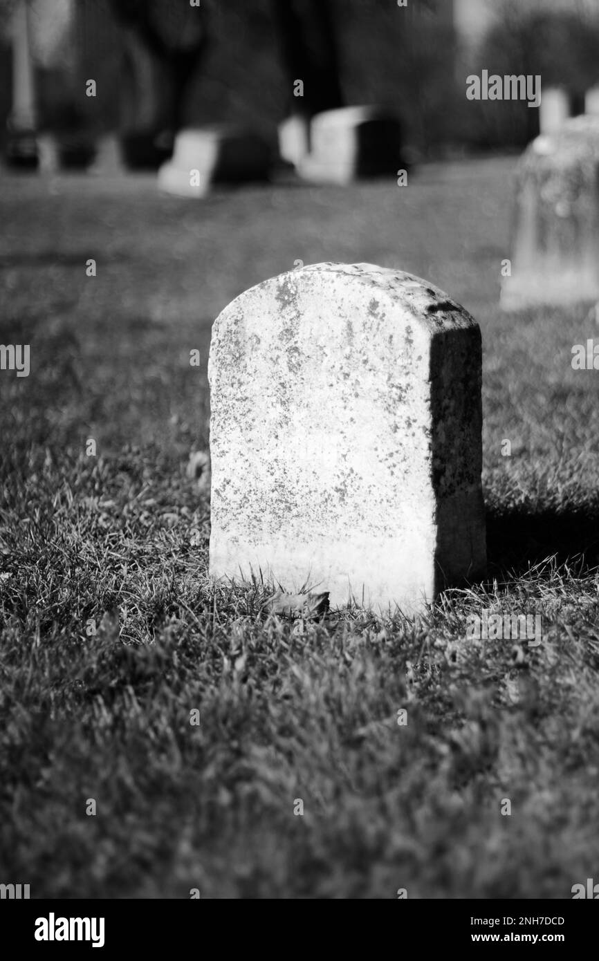 Typical common worn and weathered limestone tombstone with a blank ...