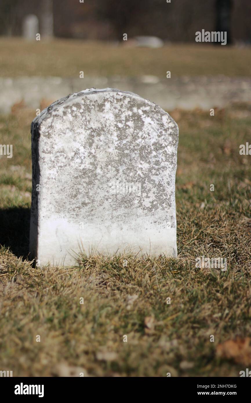 Typical common worn and weathered limestone tombstone with a blank ...