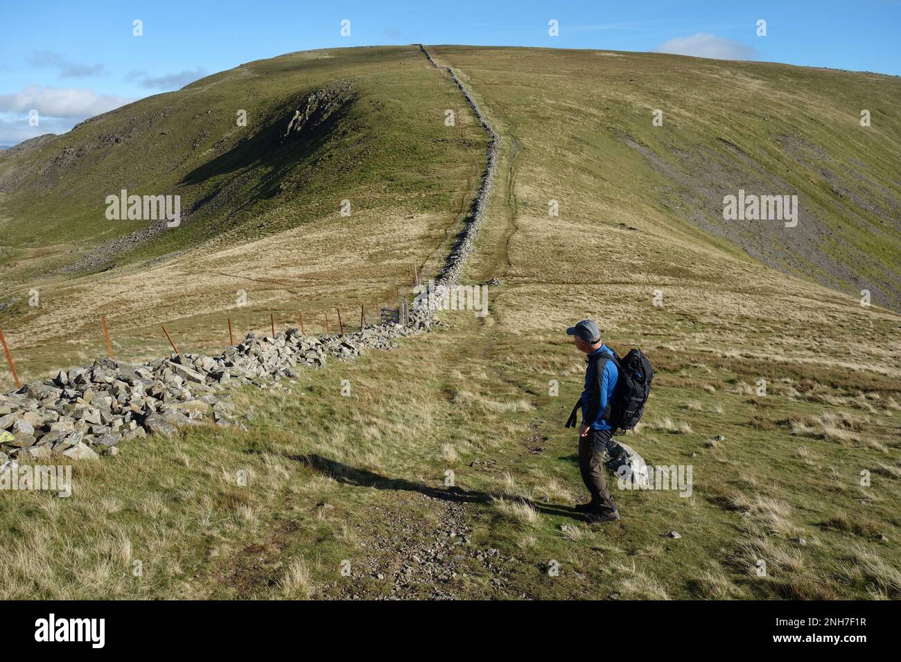 Man Standing/Looking on Path by Stone Wall Leading up to the Wainwright ...