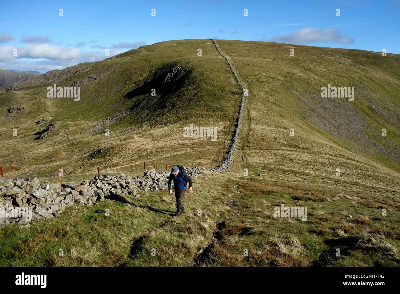 Man Walking on Path by Stone Wall above the Col Leading to the ...