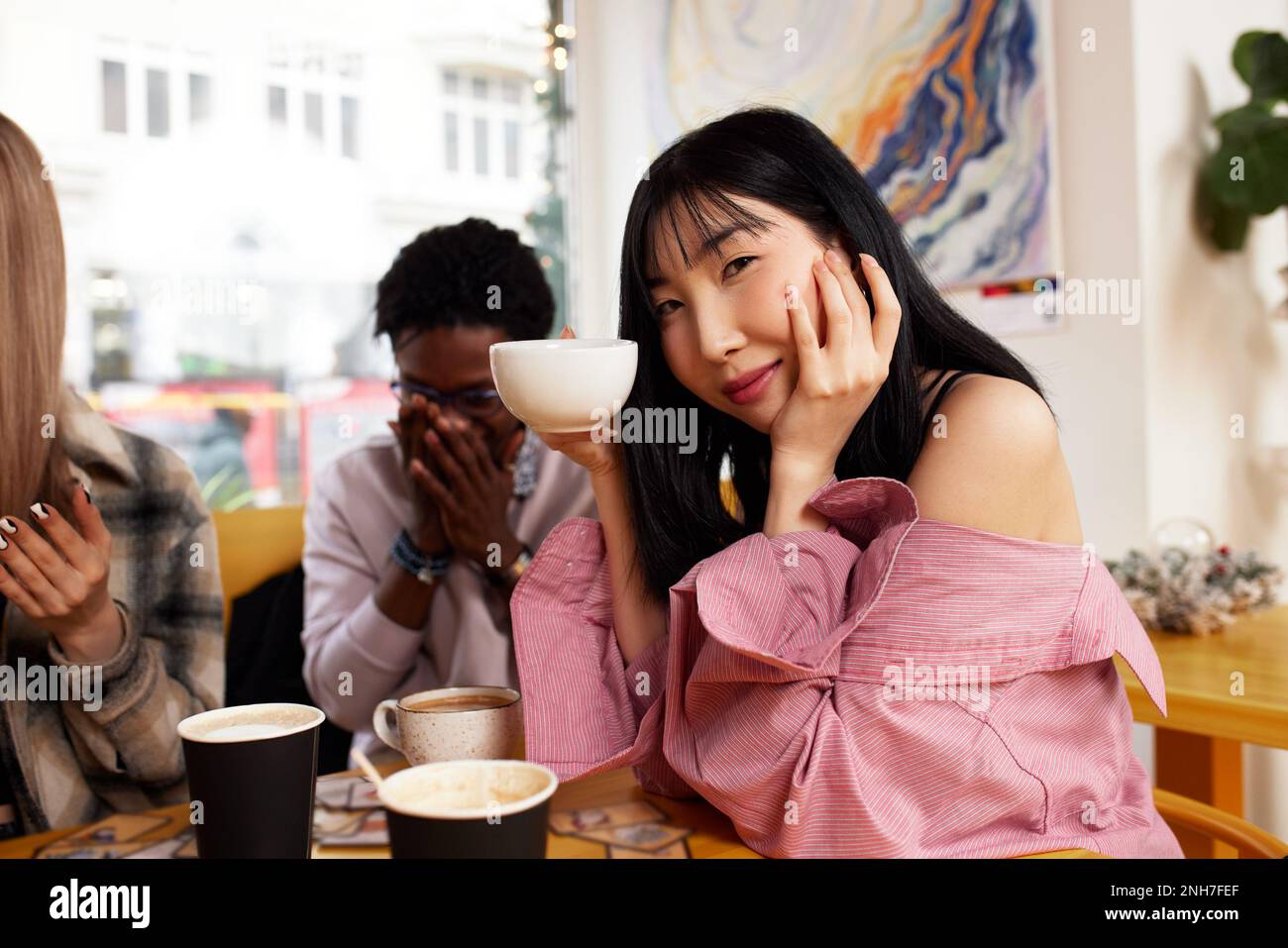 Multiracial happy young people eating pizza in pizzeria, black and ...